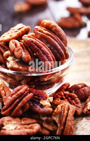 Composition with a bowl of shelled pecan nuts. Delicacies Stock Photo ...