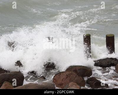 Breakwater poles and rocks at Northern Ocean in Denmark Stock Photo - Alamy