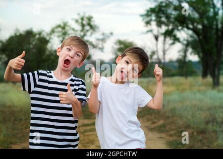 Two boys grimacing Stock Photo - Alamy