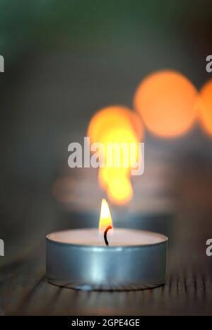 Many burning small candles on dark background, close-up Stock Photo - Alamy
