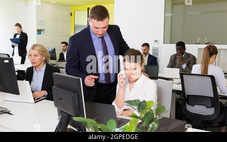 Upset girl with dissatisfied businessman in coworking space Stock Photo ...