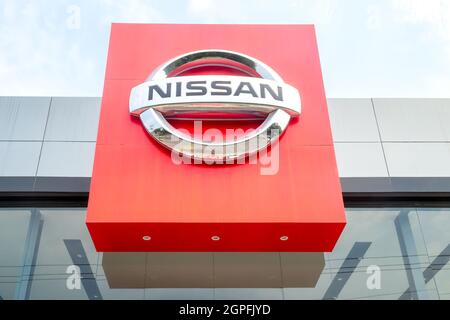 Nissan logo sign at a car dealer and service point. The Japanese ...