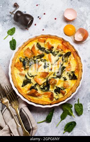 Homemade quiche with red fish, salmon, broccoli and cheese on wooden ...