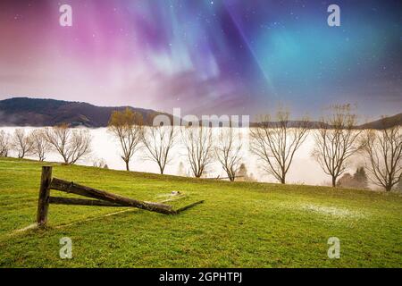 A large tack stands on a green field among the dense gray fog Stock ...
