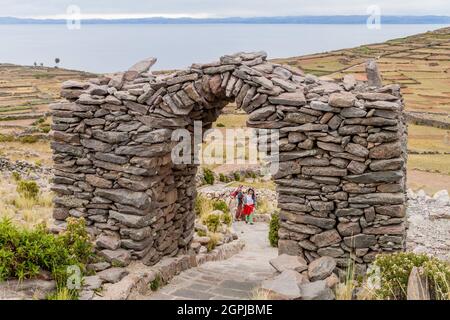 Stone arch on Pachatata hill on Amantani island in Titicaca lake, Peru ...