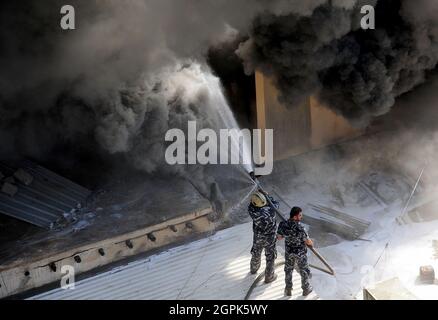 Damascus, Syria. 29th Sep, 2021. Firefighters try to extinguish a huge ...
