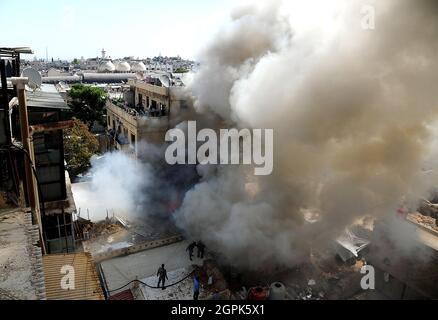Damascus, Syria. 29th Sep, 2021. Firefighters try to extinguish a huge ...