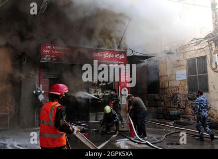 Damascus, Syria. 29th Sep, 2021. Firefighters try to extinguish a huge ...