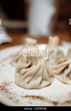 khinkali cooked on a ceramic plate Stock Photo - Alamy