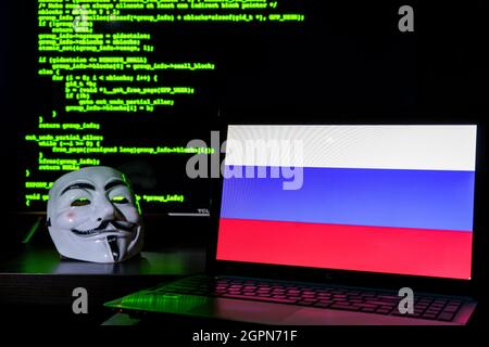 Russian anonymous hackers with vendetta mask. Russian flag and ...