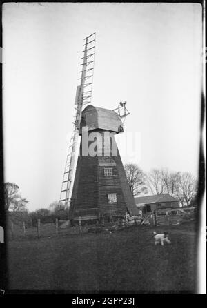 A white smock mill built in 1869 onto a two storey red brick base with ...