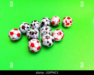 colored sweet balls group with green background Stock Photo - Alamy