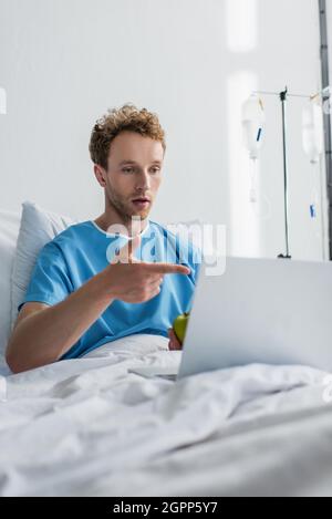 sick man having video call on laptop at home Stock Photo - Alamy