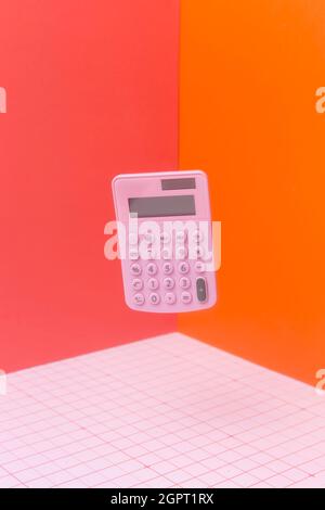Math arrangement with calculator floating Stock Photo - Alamy