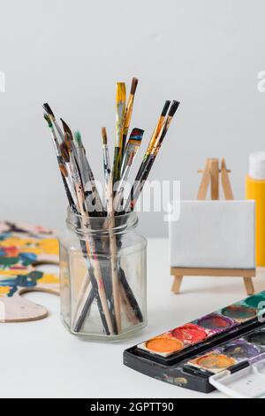 Artist props collection on table. composition of messy stationery tools ...