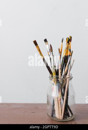 Artist props collection on table. composition of messy stationery tools ...