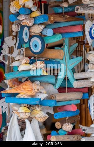 Selection of crafts and hand made souvenirs for sale on a market stall ...