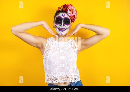 Mexican Catrina, portrait of young latin woman holding mexican maracas ...