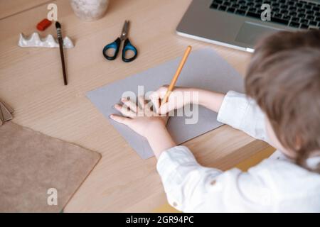 Child trace around a hand on paper with crayons. A simple drawing of a ...