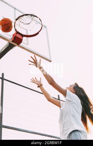 Girl basketball player throws the ball in the game Stock Photo - Alamy