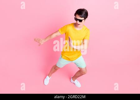 Photo of sweet funky guy dressed white sweater arms sides jumping high ...