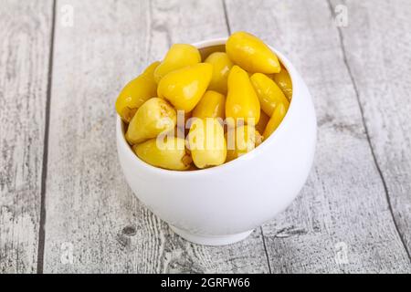 Pickled Yellow spicy mini pepper in the bowl Stock Photo - Alamy