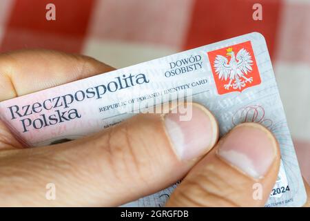 Polish ID card held in hand, Identity document Stock Photo - Alamy