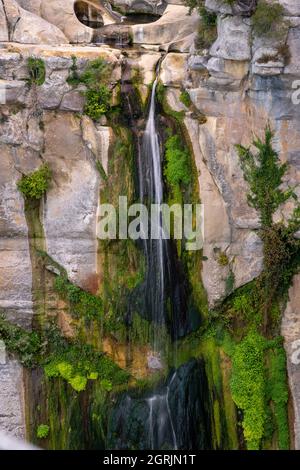 Beautiful waterfall between large rocks in the autumn forest ...