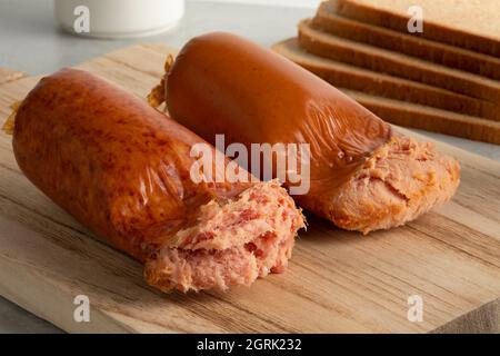 Traditional German coarse and fine Teewurst open in plastic close up ...