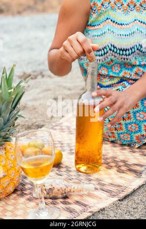 Unrecognizable woman uncorking a bottle of wine Stock Photo - Alamy