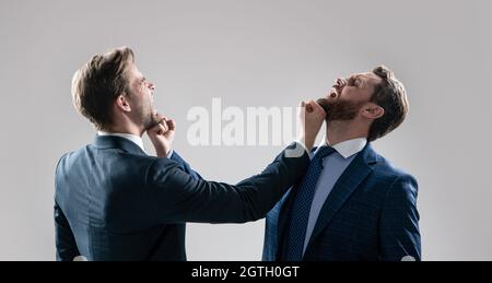 fighting businesspeople. dissatisfied men. fist in face. colleagues ...