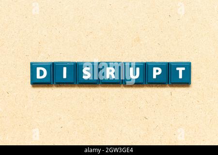 Tile alphabet letter with word disrupt in red color rack on wood ...