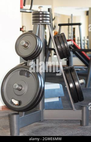 Barbell plates holder rack in the gym Stock Photo - Alamy