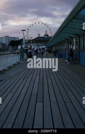 British holiday makers at the seaside. Bournemouth promenade England UK ...
