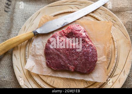 A raw, uncooked ox cheek bought from a supermarket in the UK. Ox cheeks ...
