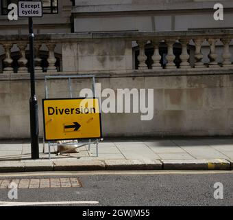 Yellow diversion sign board with black Right pointing arrow Stock Photo ...