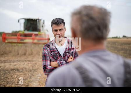 Two farmers standing in soyfield during harvest and arguing Stock Photo ...
