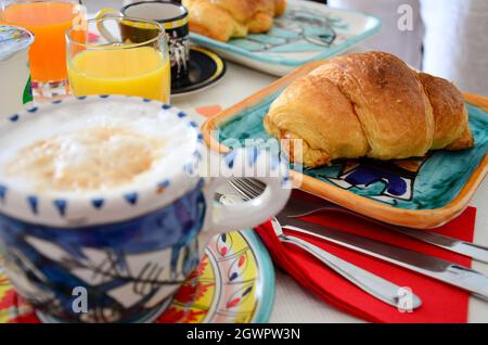 Typical italian breakfast with cappuccino, cornetto, espresso and ...