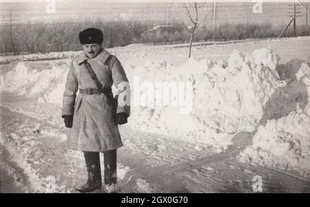 A man in a winter military uniform of an officer of the Soviet army ...