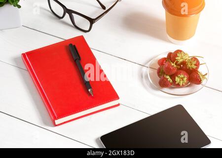 Stylish minimalistic workplace with tablet and notebook and glasses in ...