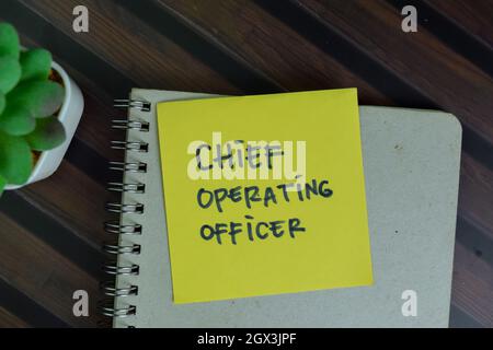 COO - Chief Operating Officer write on sticky notes isolated on Wooden ...
