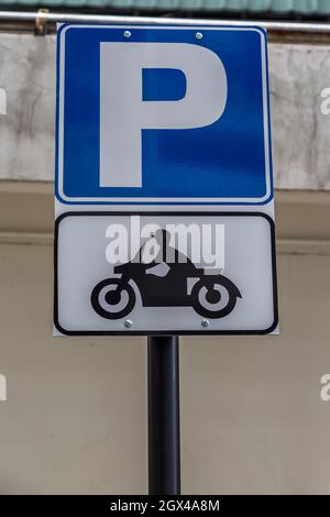 Blue Sign of motorbikes parking background Stock Photo - Alamy
