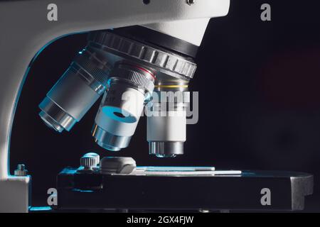 Microscope in laboratory at night. Microbiology and research concept ...