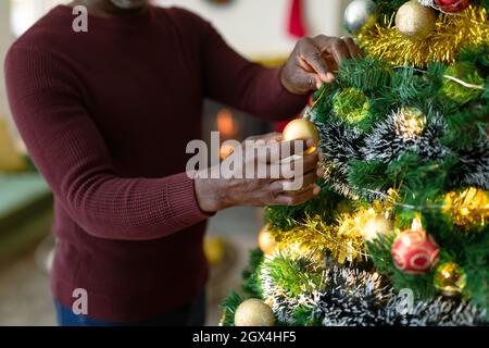Midsection of senior african american man sitting with intertwined ...