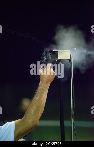 Race official holding a starting gun at the beginning of a track event ...