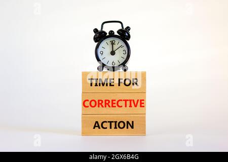 Corrective action symbol. Wooden blocks with words 'Corrective action ...