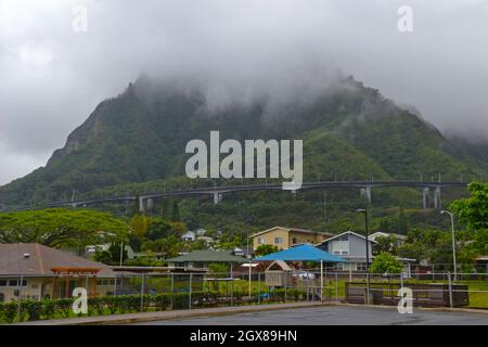 Windward Oahu neighborhood with a view of the Koolau cliffs on a cloudy ...
