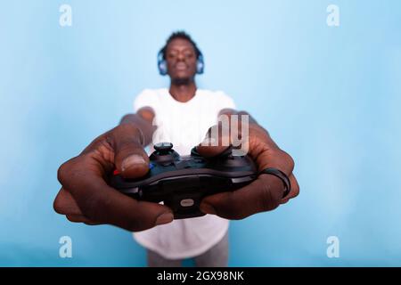 Man in headphones controller in hands playing game console lifestyle ...