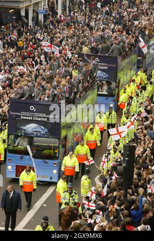 The England rugby team bus makes its way through the thousands of ...