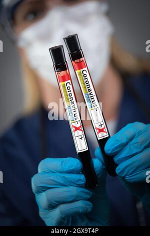 A medical worker holds testing tubes at a mobile testing center during ...